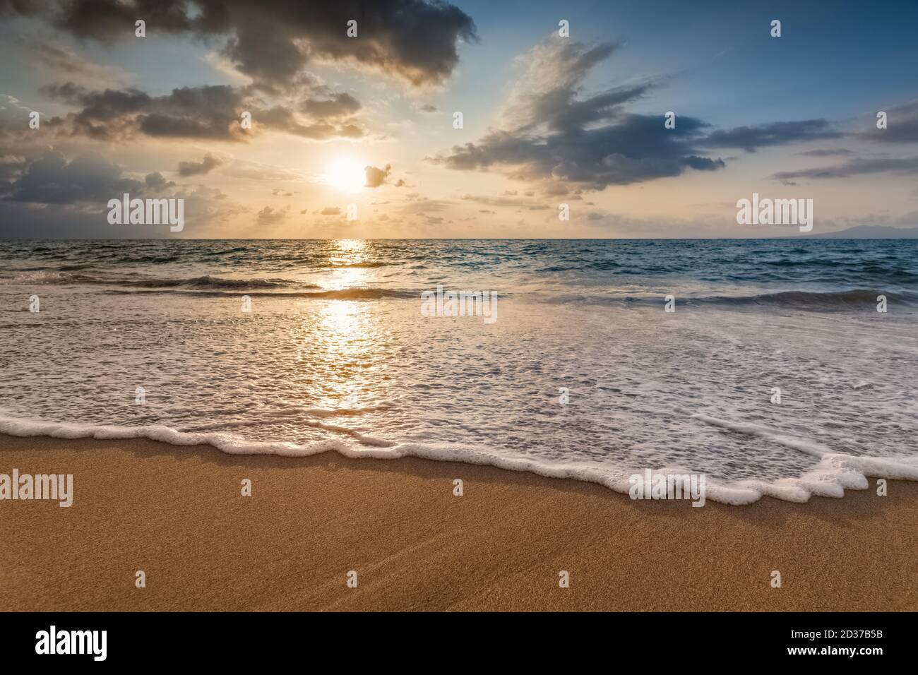 A Sunset Ocean Wave is Breaking on the Sea Shore with the Sun Setting ...