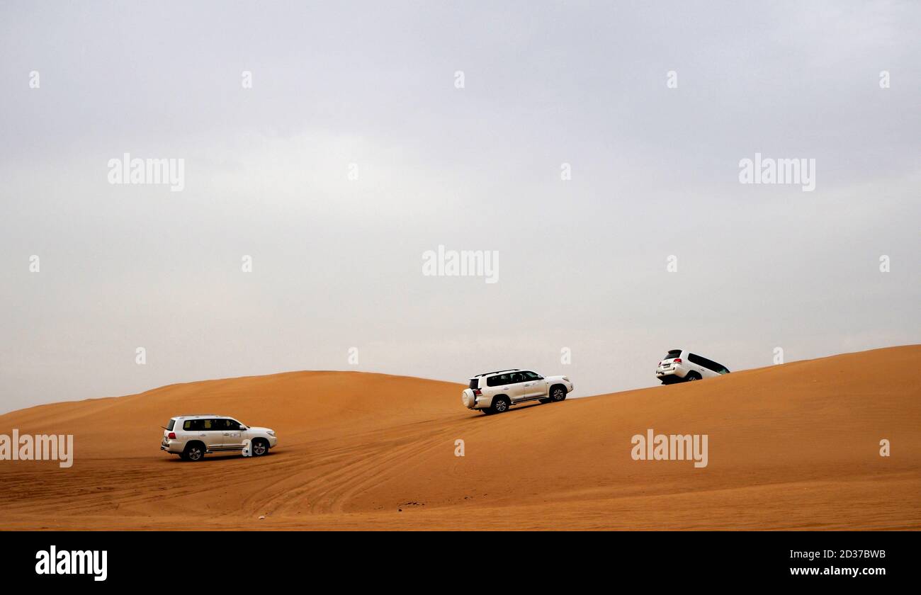 Off roaders climbing sand dunes in Dubai Stock Photo - Alamy