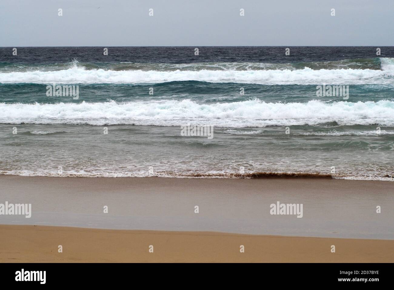 Waves rolling onto the beach Stock Photo - Alamy