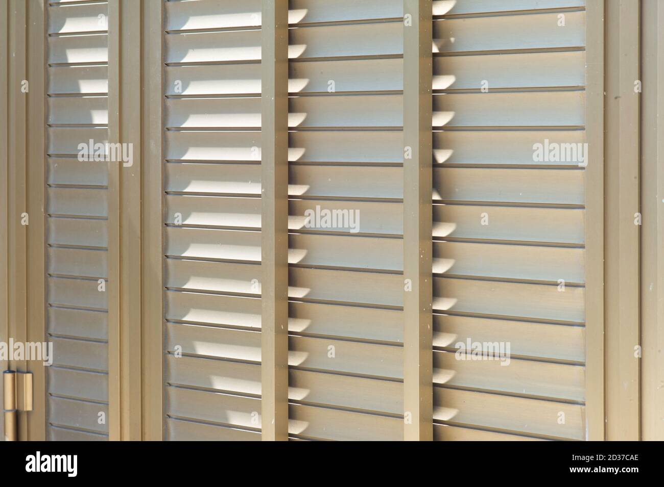 Closed gold-colored metallic shutters, metal blinds with hinge Stock ...