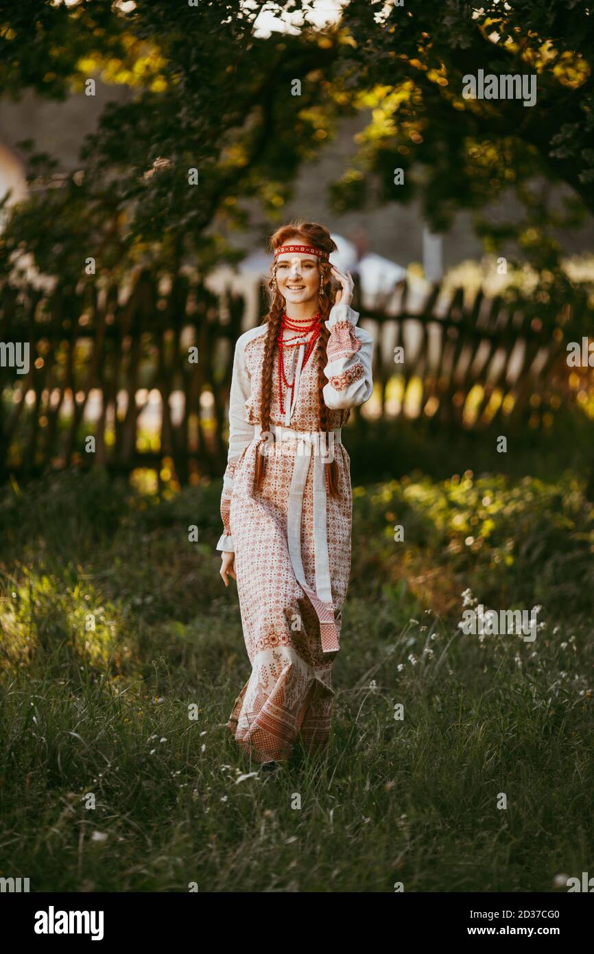 A beautiful Slavic girl with long blonde hair and brown eyes in a white ...