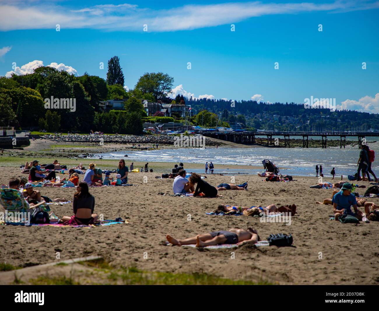Sunbathers on a beach Stock Photo - Alamy