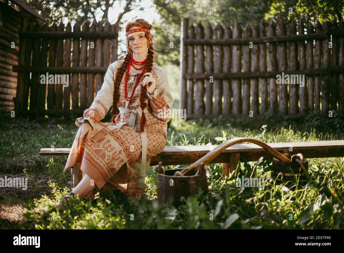 A beautiful Slavic girl with long blonde hair and brown eyes in a white ...