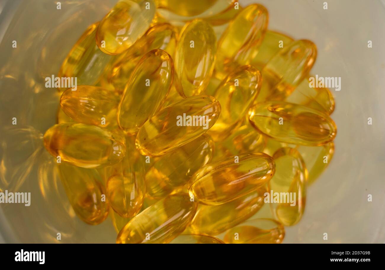 Extreme close up of fish oil orange yellow softgels capsules fish oil ...