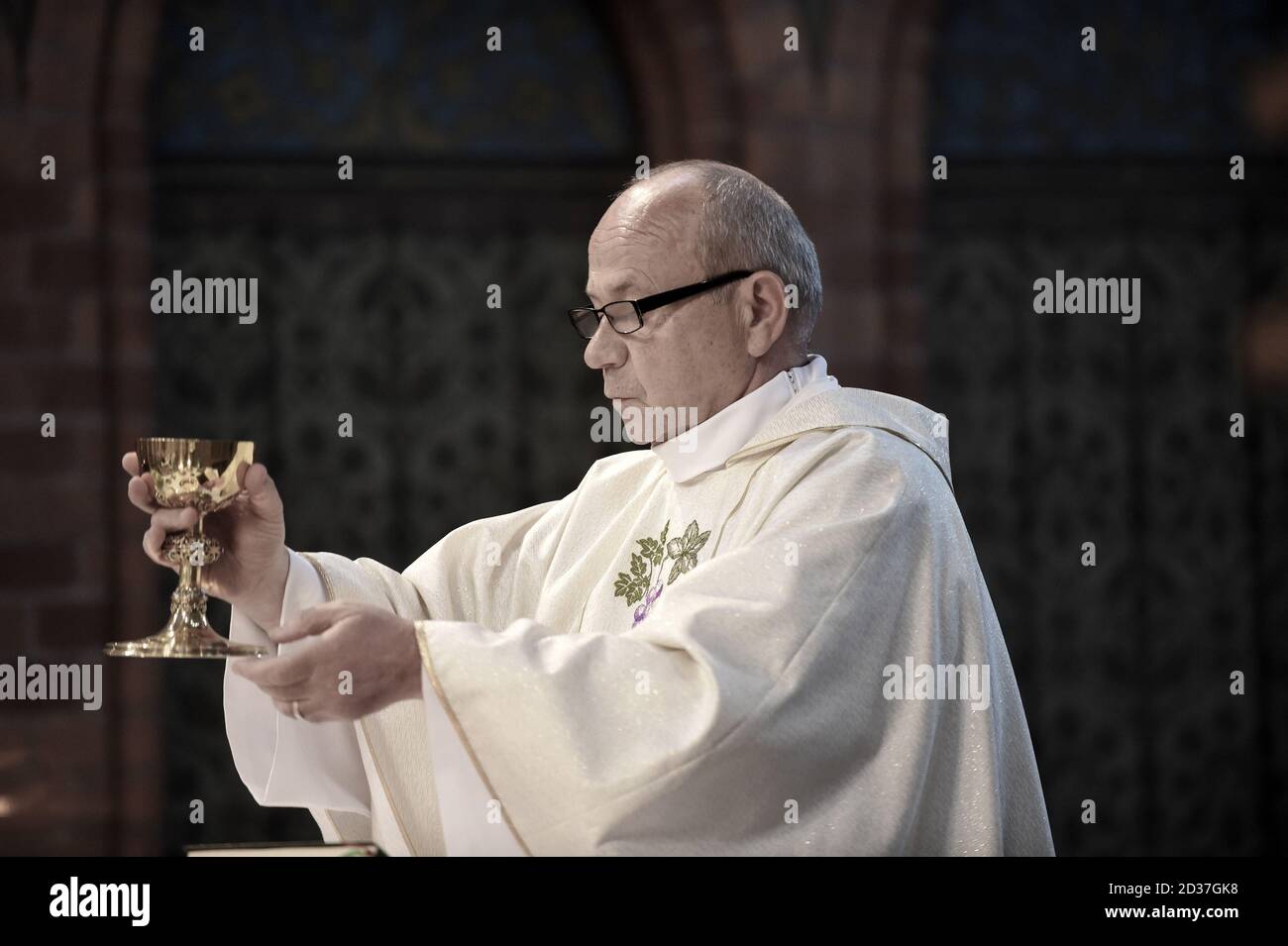Luneburg, Germany - June 13, 2015: catholic priest with chalice cup ...