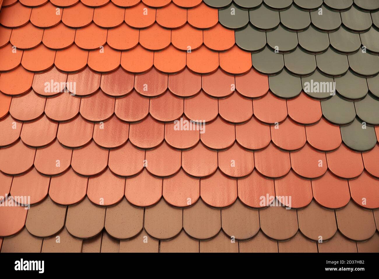 Roofing. Roof tiles of the same shape but differing in color and ...