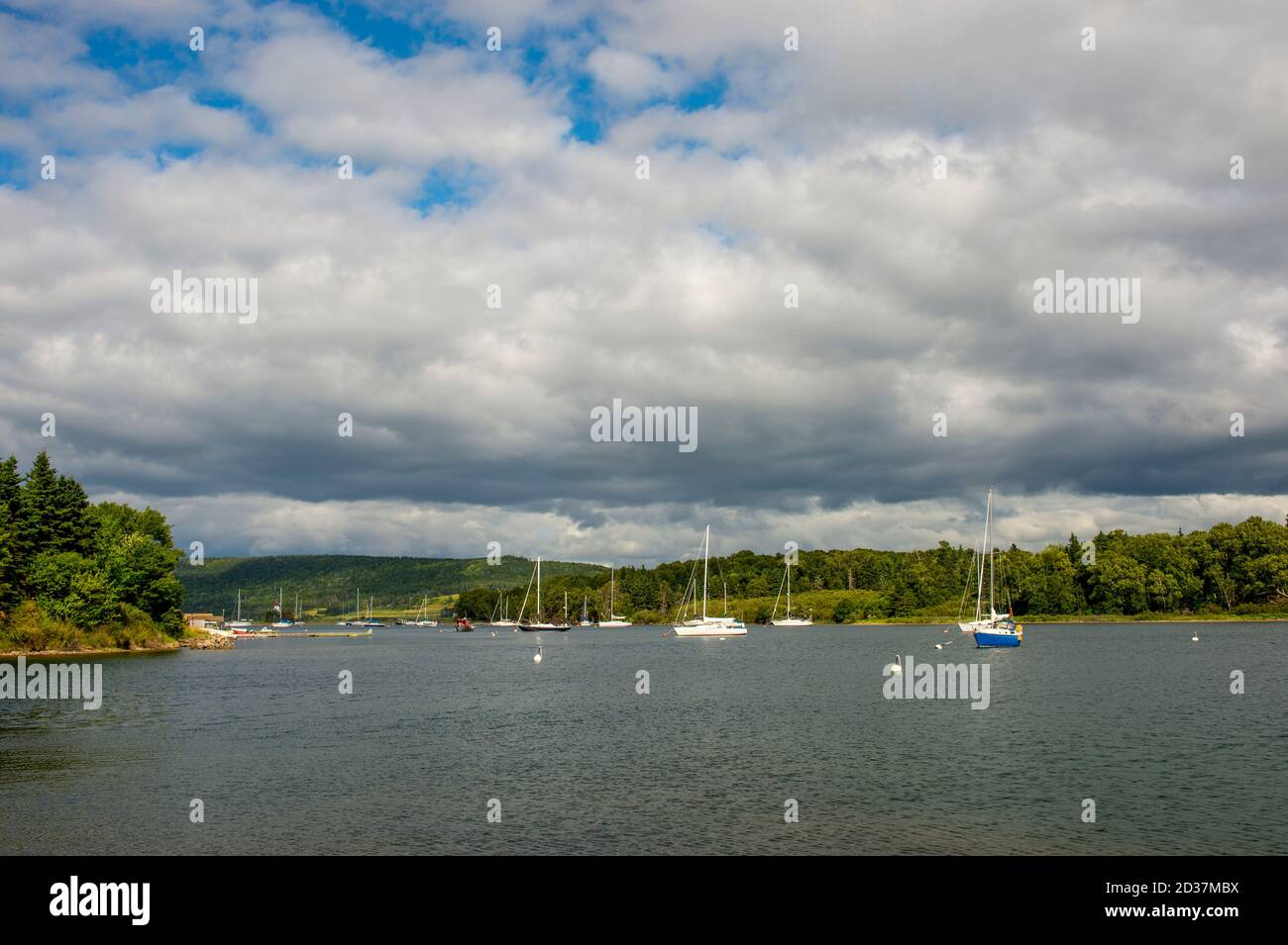 View of Bras d'Or Lake with sailboats at anchor in Baddeck, Nova Scotia ...
