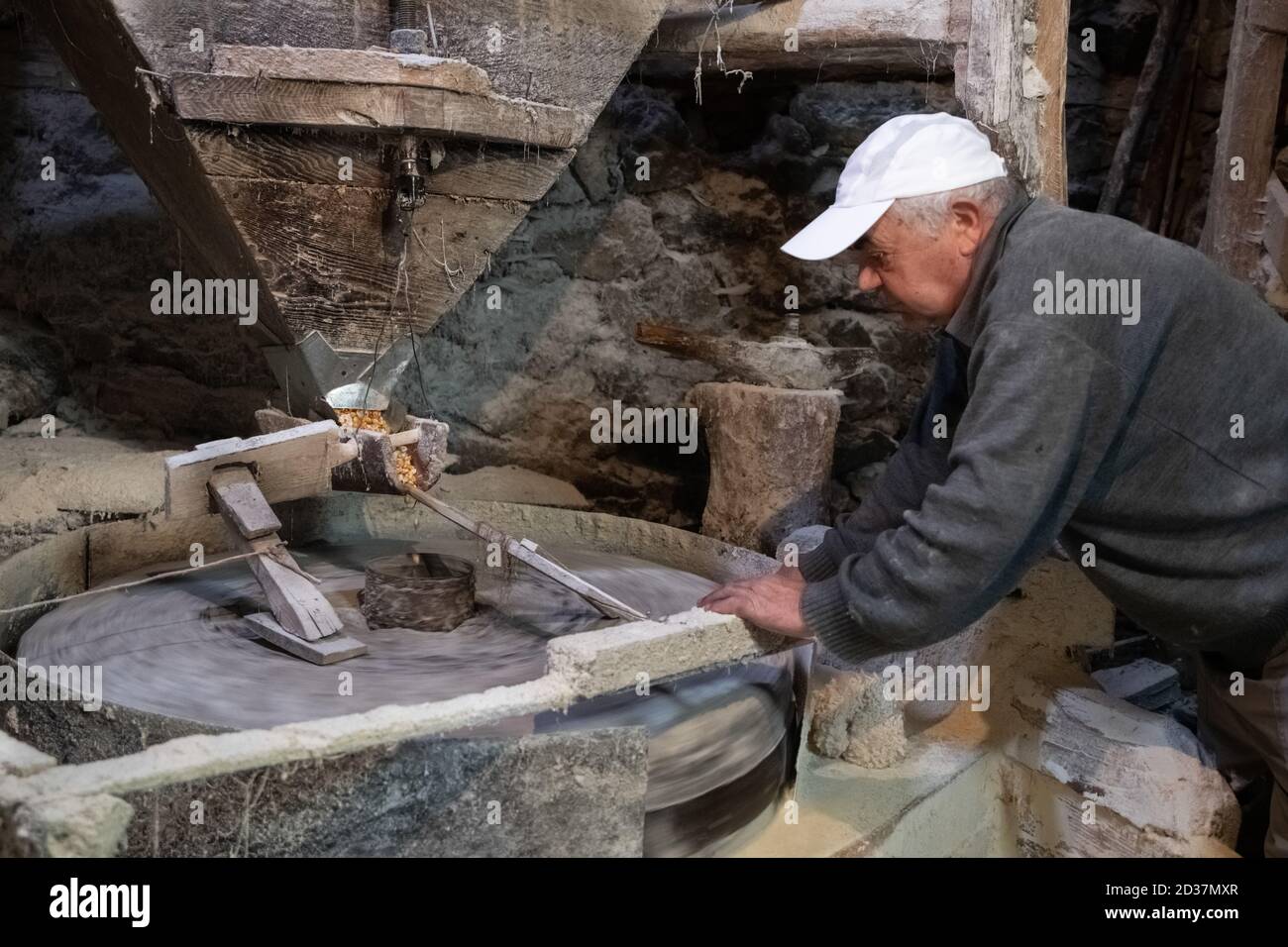 Old mill for grinding grain up close. The miller grinds grain Stock ...