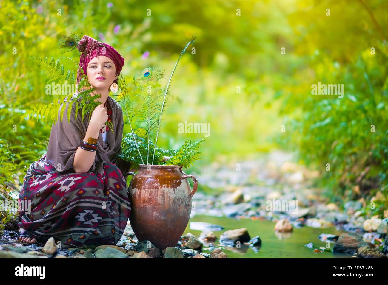 Young woman in traditional clothing getting water in the spring Stock ...
