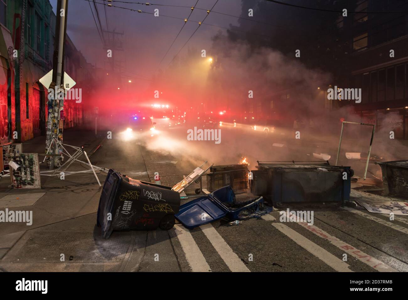 Seattle, USA. 26th Sep, 2020. Early in the evening police by smoldering ...