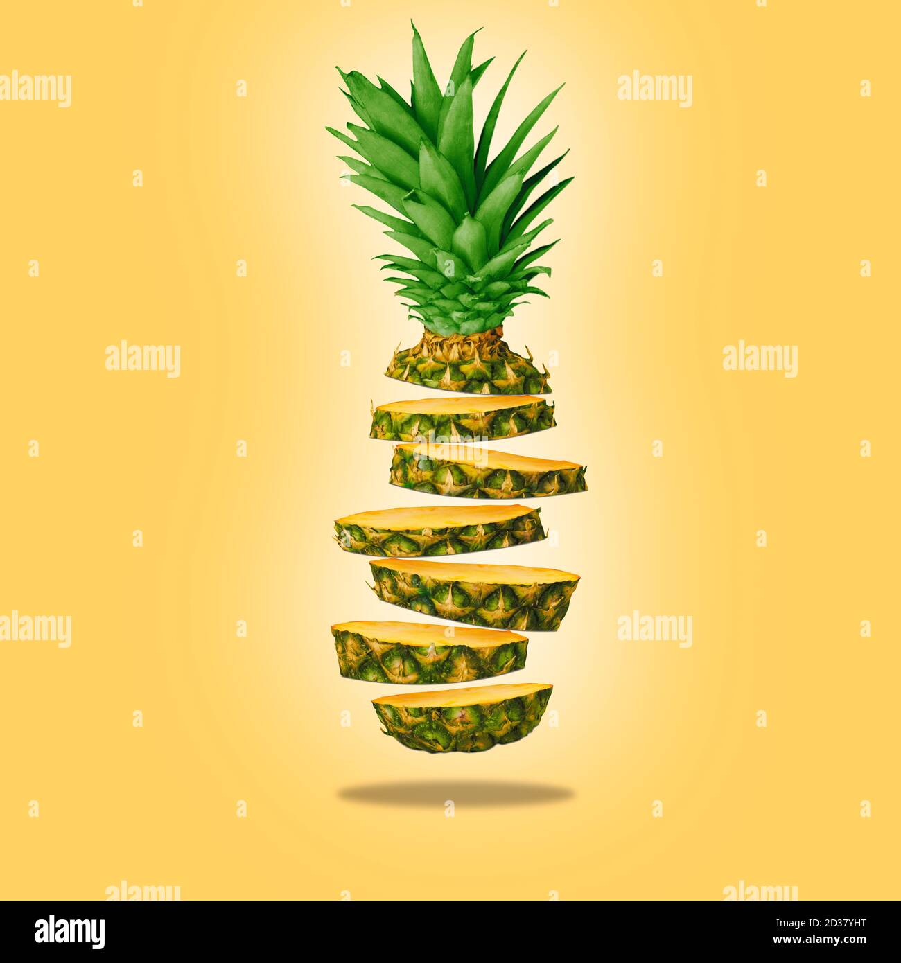 Clean and isolate pineapple levitating on a yellow background. High ...