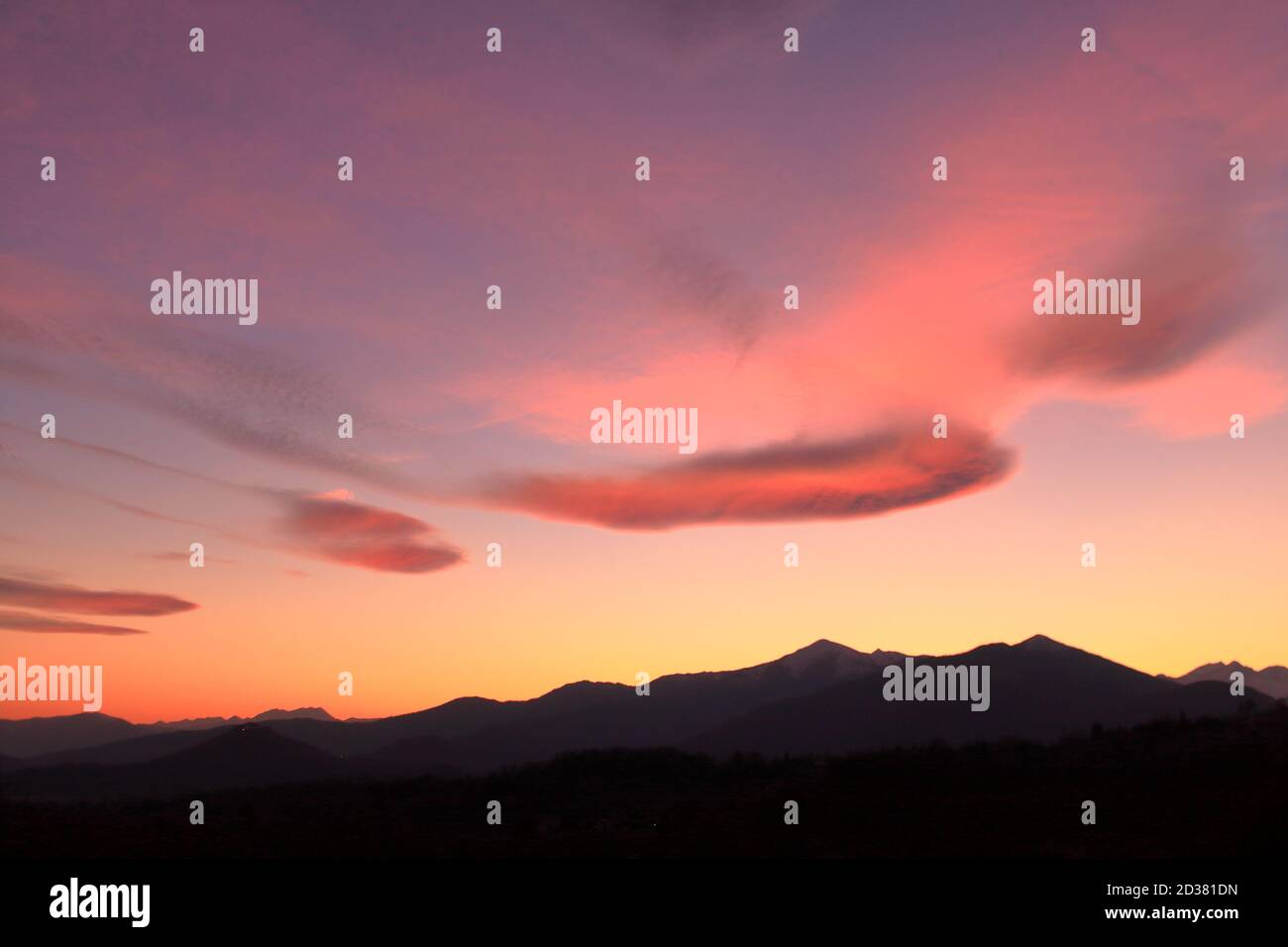 a romantic sunset with pink clouds over the Italian Alps Stock Photo ...