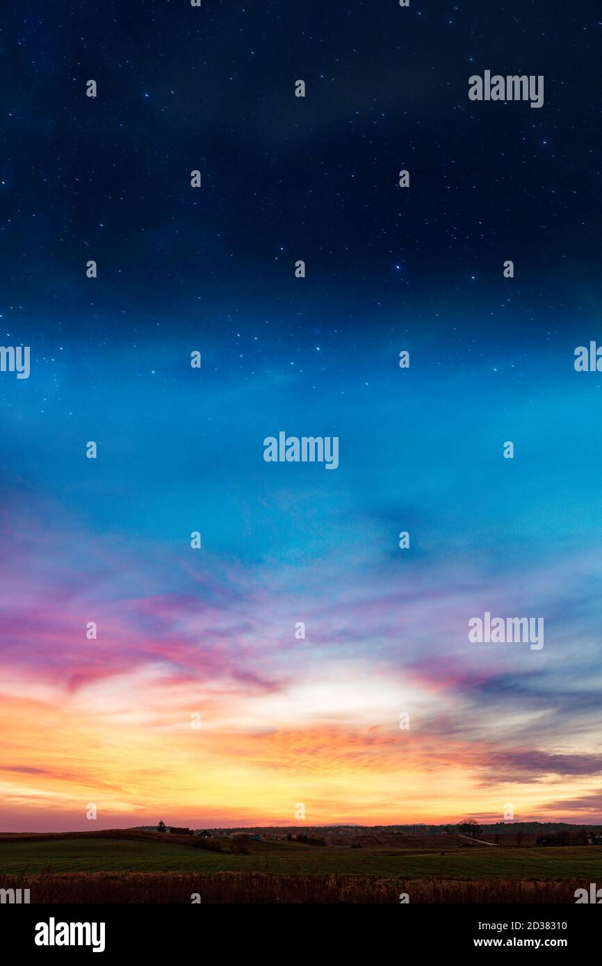 Colorful sky with a setting sun and stars Stock Photo - Alamy
