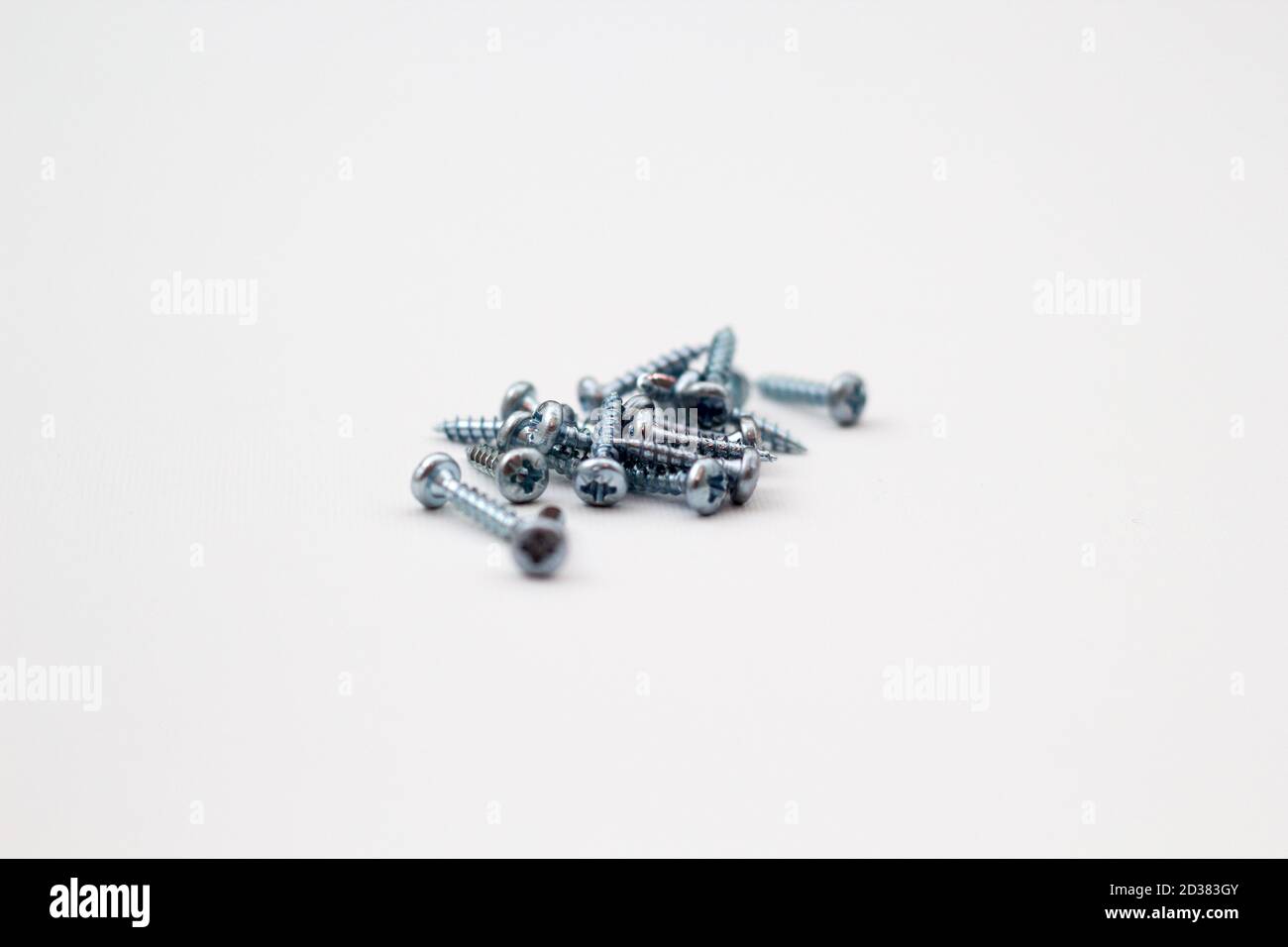 Closeup of a screws forming on white surface Stock Photo - Alamy