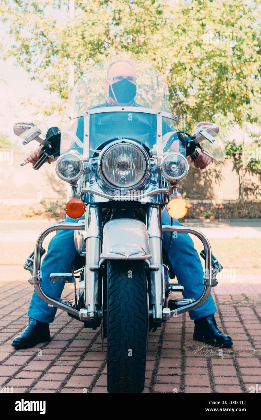 a front view of custom chopper motorcycle with biker Stock Photo - Alamy