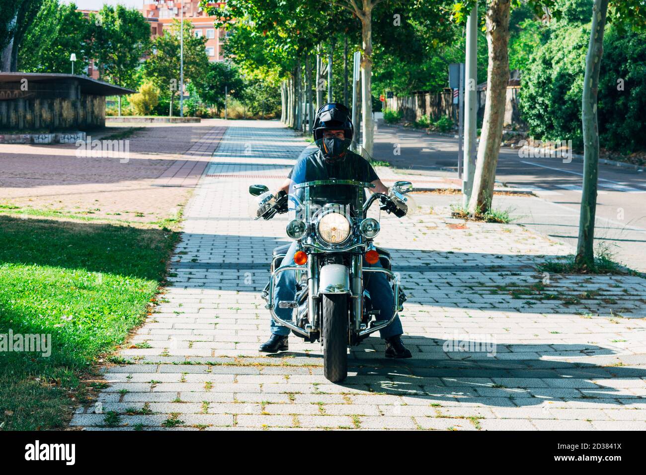 a front view of custom chopper motorcycle with biker Stock Photo - Alamy