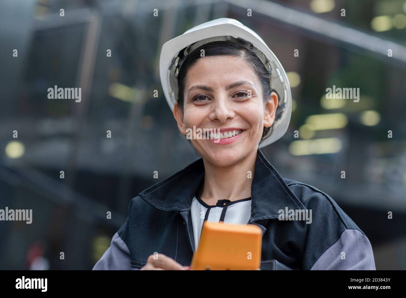 female engineer with helmet working outside Stock Photo - Alamy
