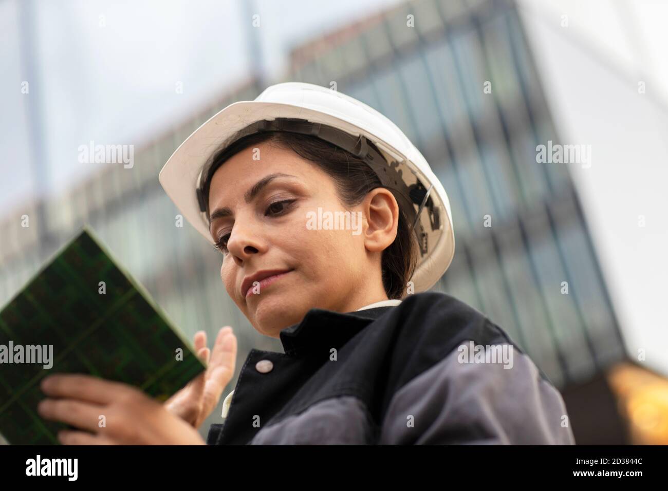 female engineer with helmet working outside Stock Photo - Alamy