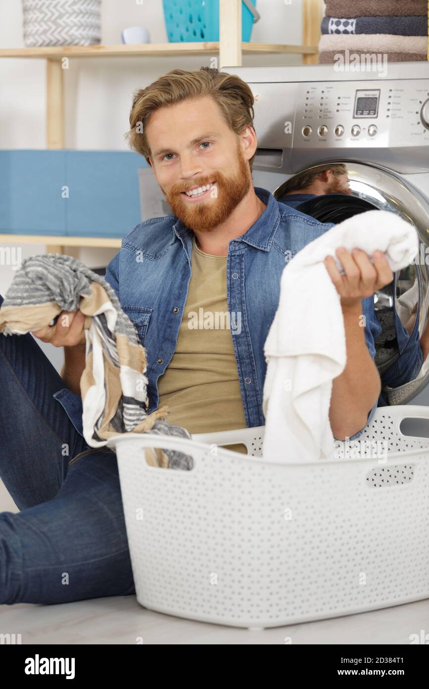 happy man with laundry basket Stock Photo - Alamy