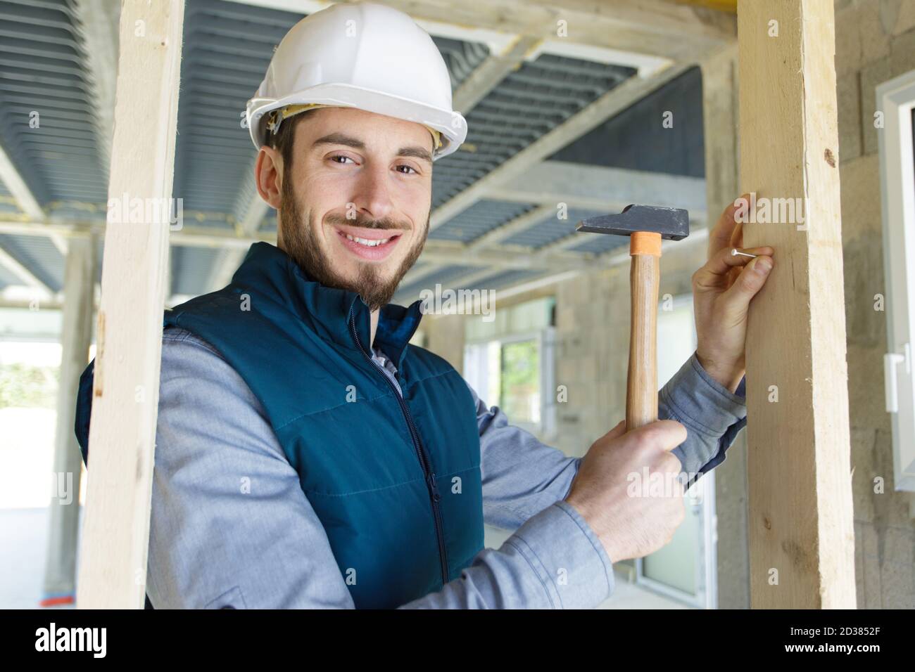 focused young man is building a roof Stock Photo - Alamy