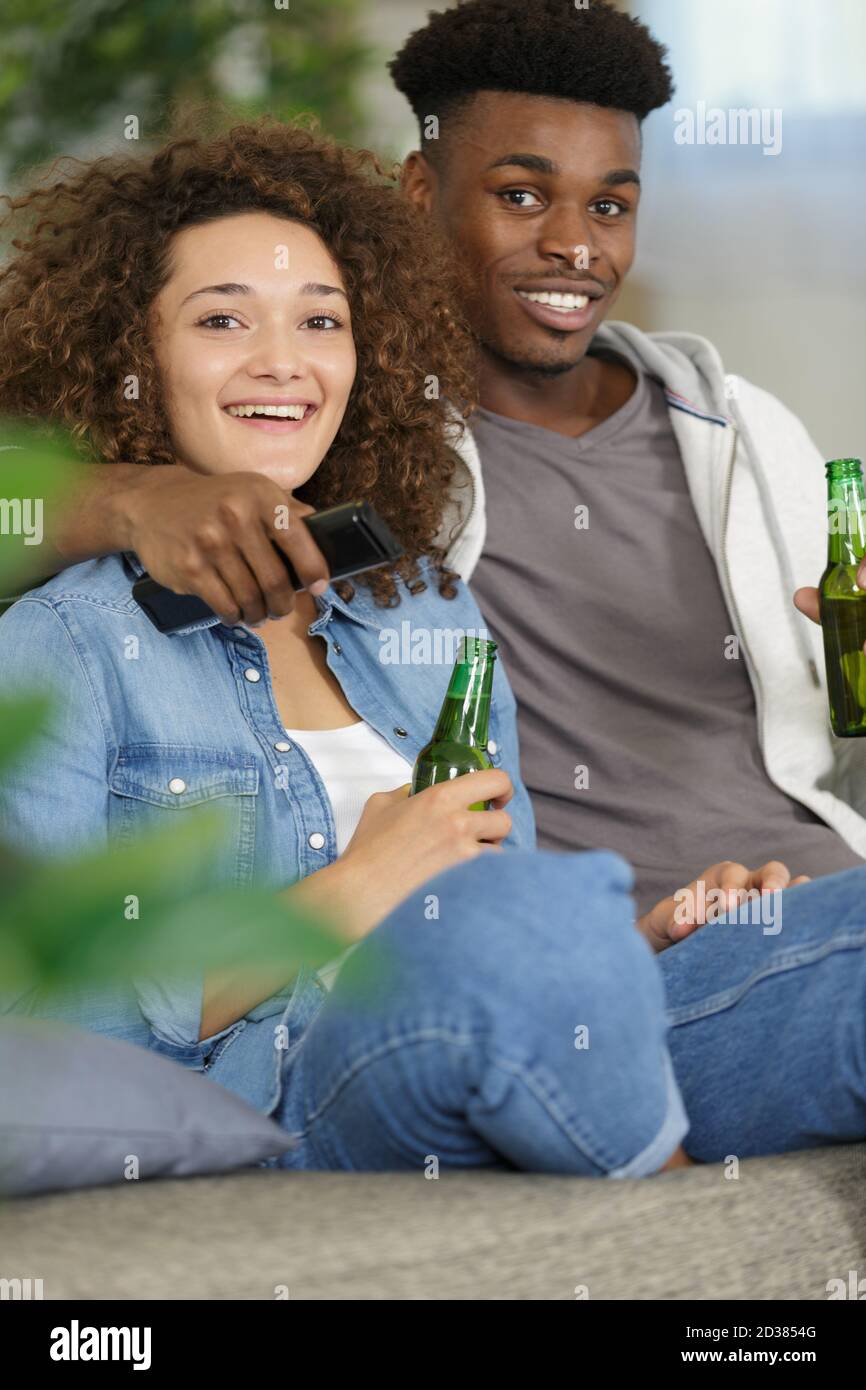 happy friends or couple with beer talking at home Stock Photo - Alamy