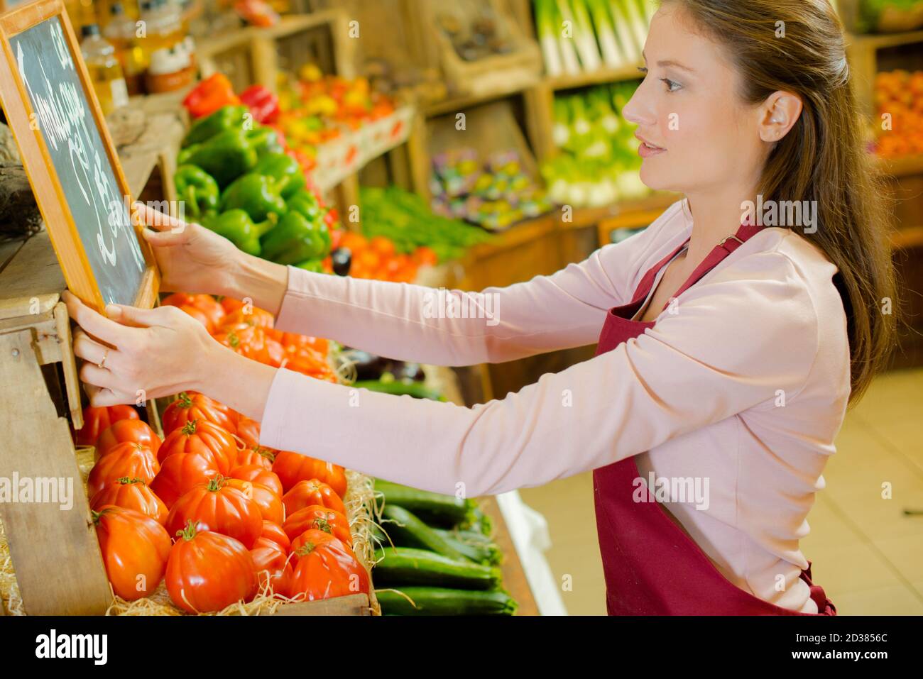 Shop assistant taking care of her stand Stock Photo - Alamy