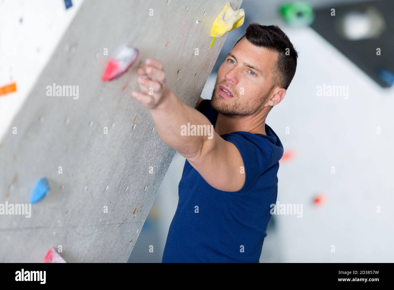 free climber man climbing on practice wall indoors Stock Photo - Alamy