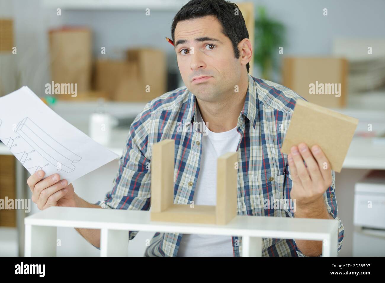 frustrated man working with wood Stock Photo - Alamy