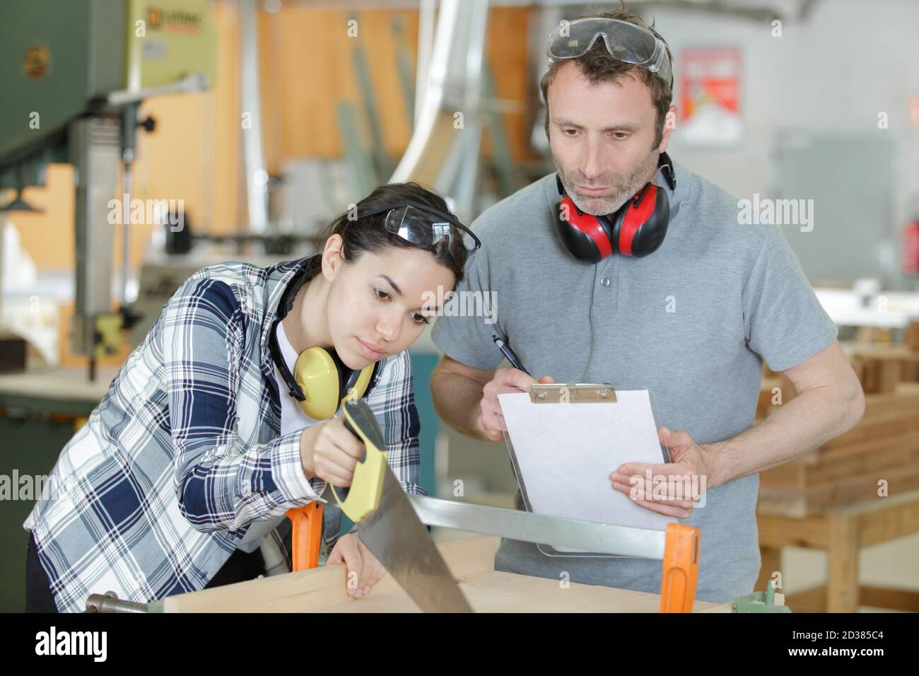 carpenter female apprentice using saw Stock Photo - Alamy