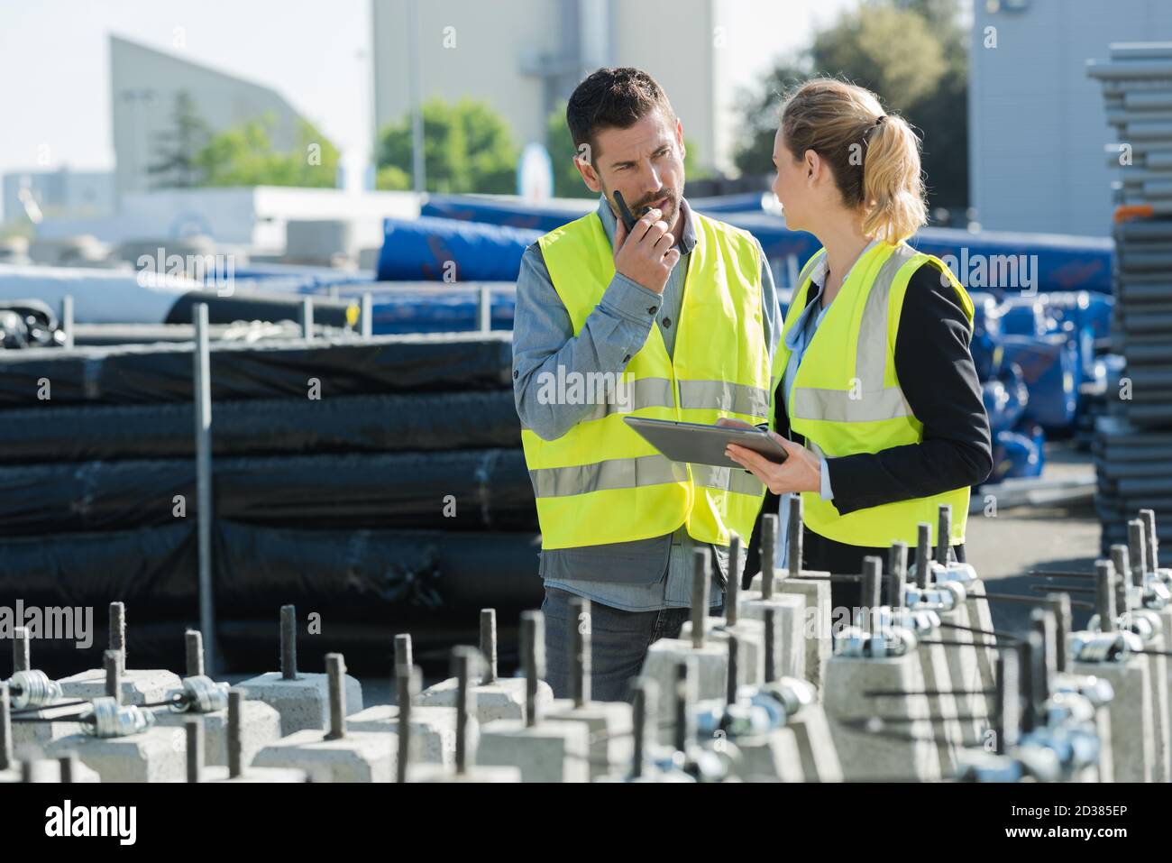 workers in building materials yard talking into walkie-talkie Stock ...