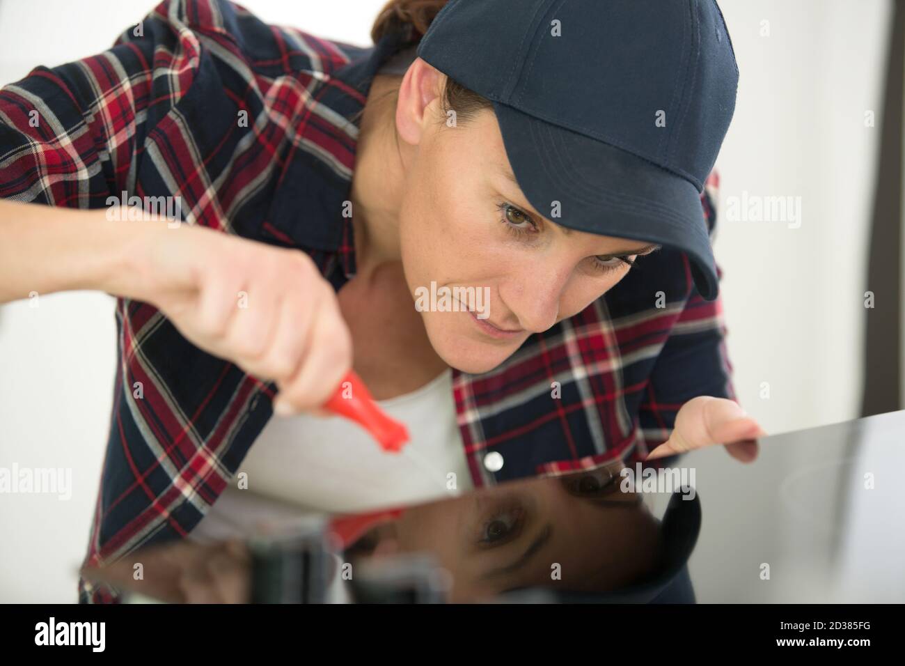 woman screwing down a screw Stock Photo - Alamy