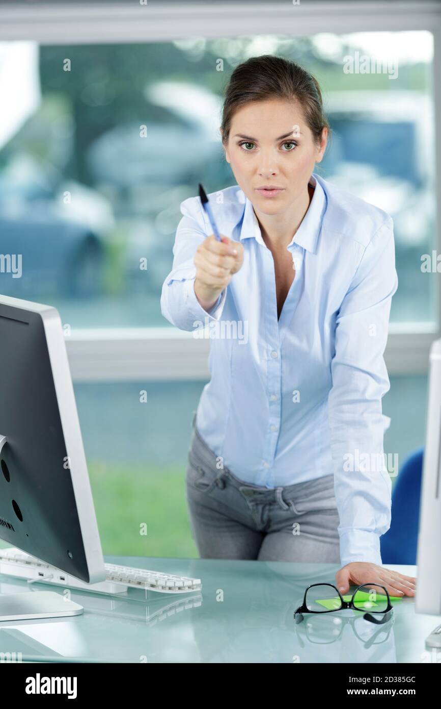 upset beautiful woman manager pointing finger Stock Photo - Alamy