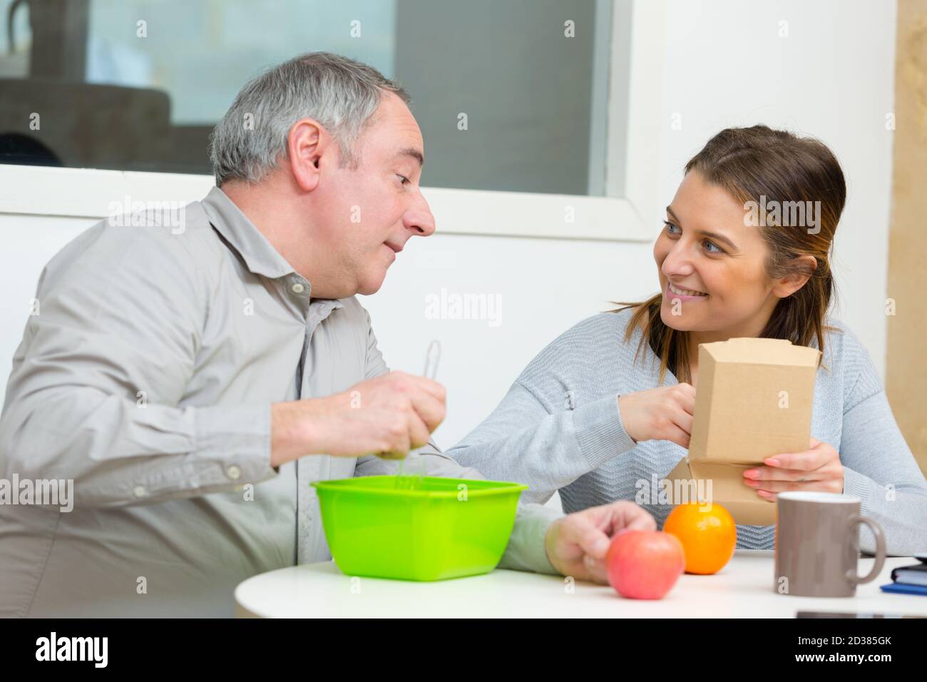 happy colleagues with sandwiches talking at lunch break Stock Photo - Alamy