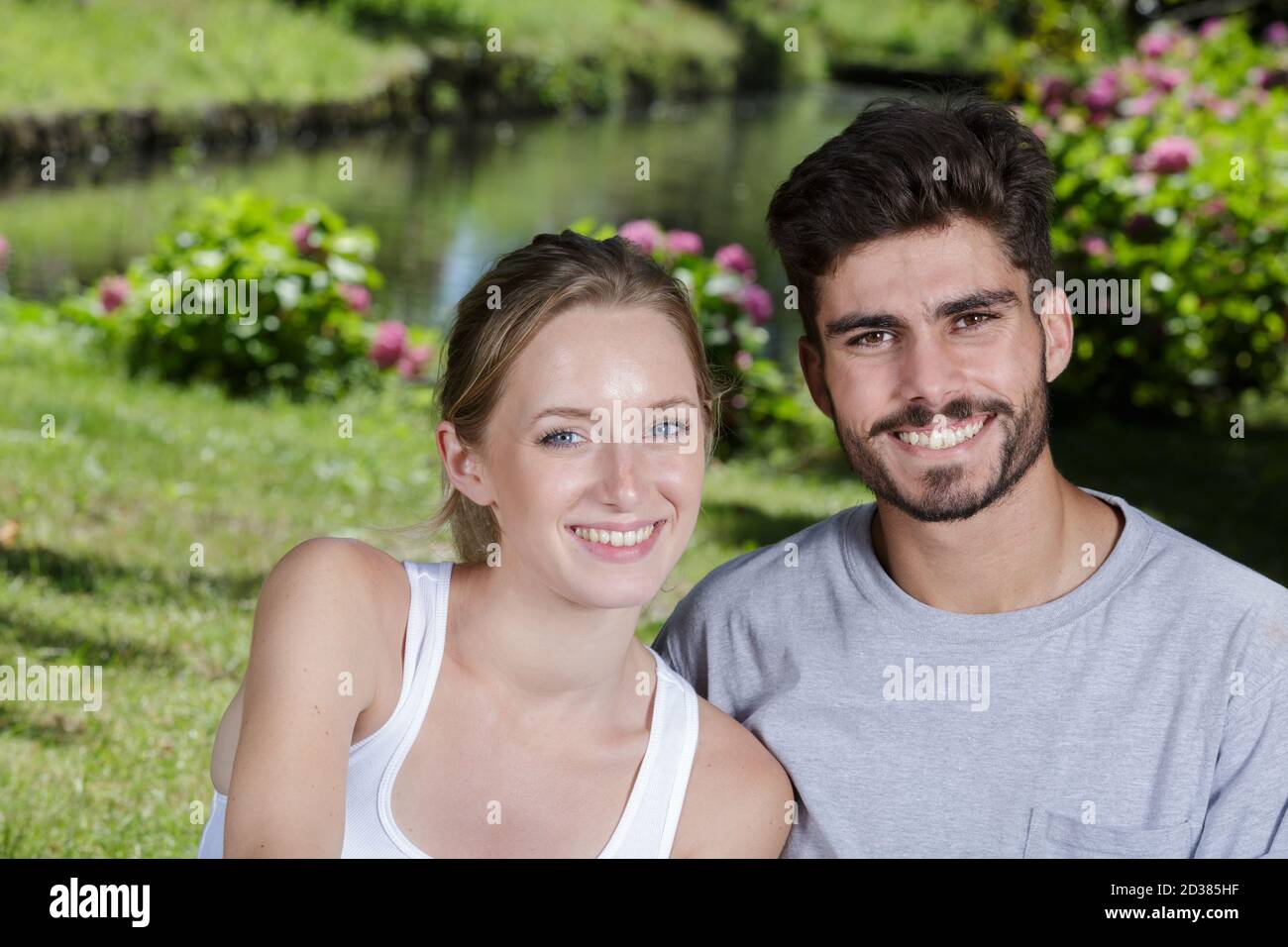 beautiful young couple on the lake background Stock Photo - Alamy