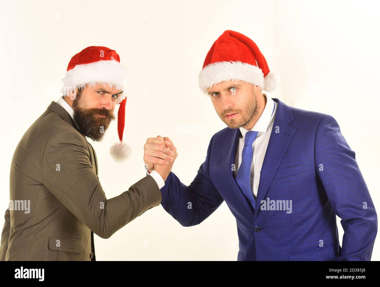 Business and Christmas vacation concept. Men in classic suits and Santa ...