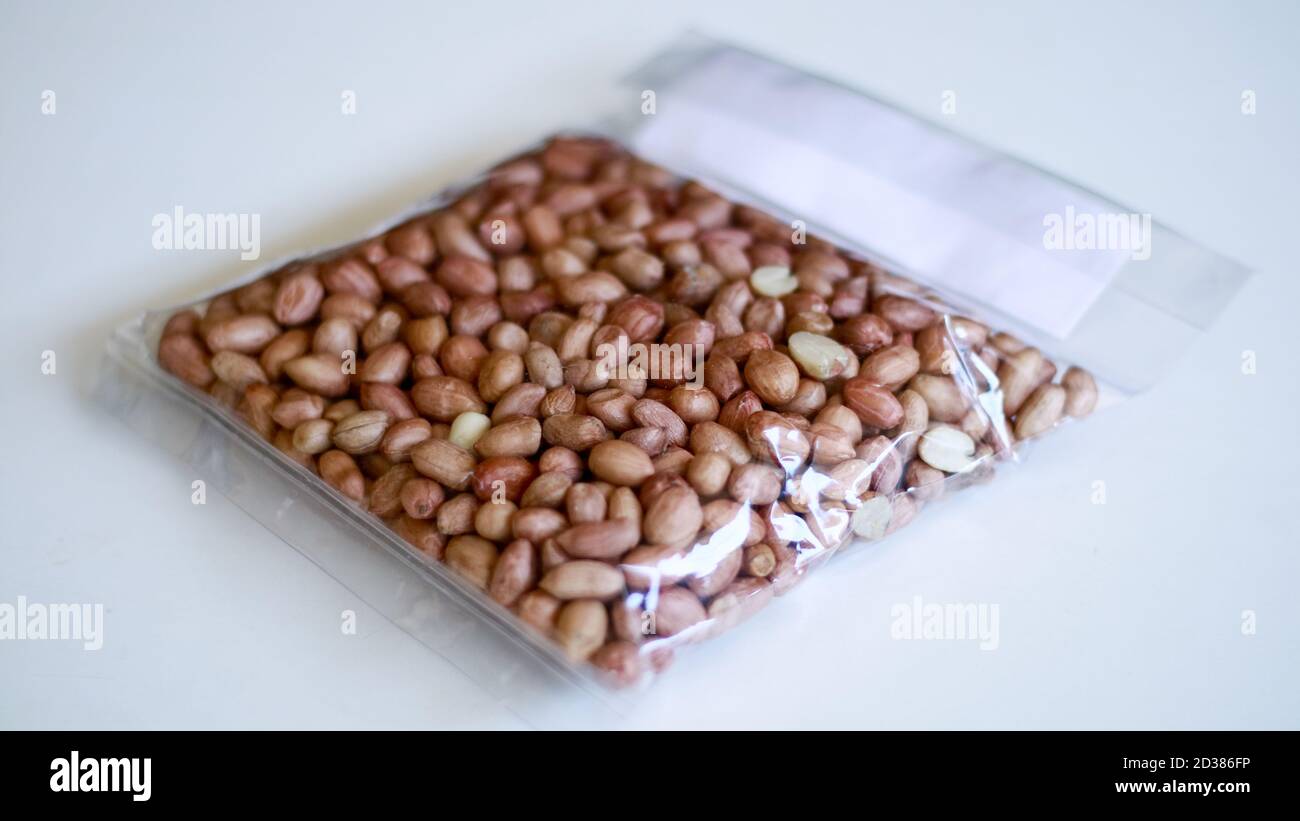 Peanuts in plastic packaging on white background Stock Photo - Alamy