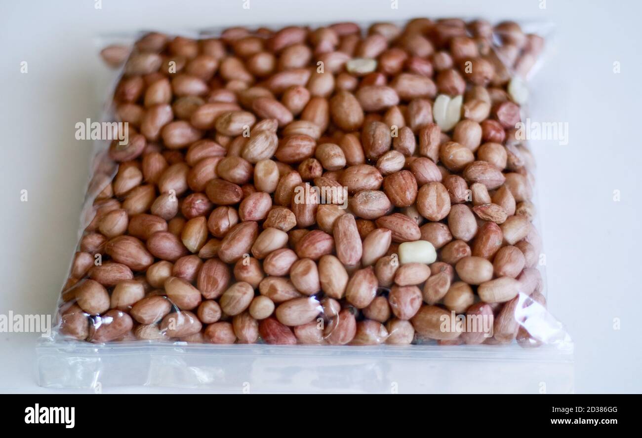 Peanuts in plastic packaging on white background Stock Photo - Alamy