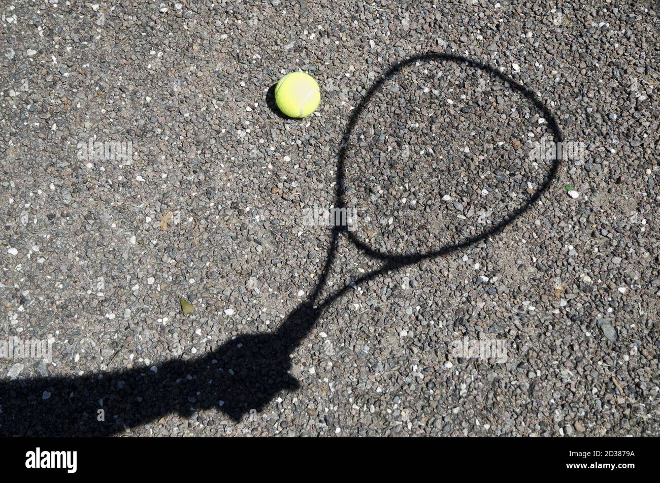 Shadow Playing Tennis with Racket and ball on the Gravel Stock Photo ...