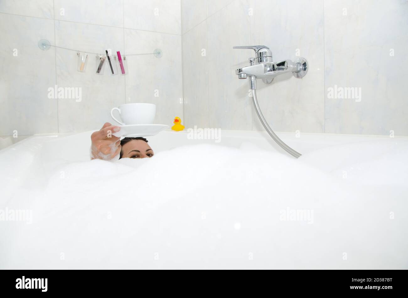 Woman bathing in coffee cup hi-res stock photography and images - Alamy