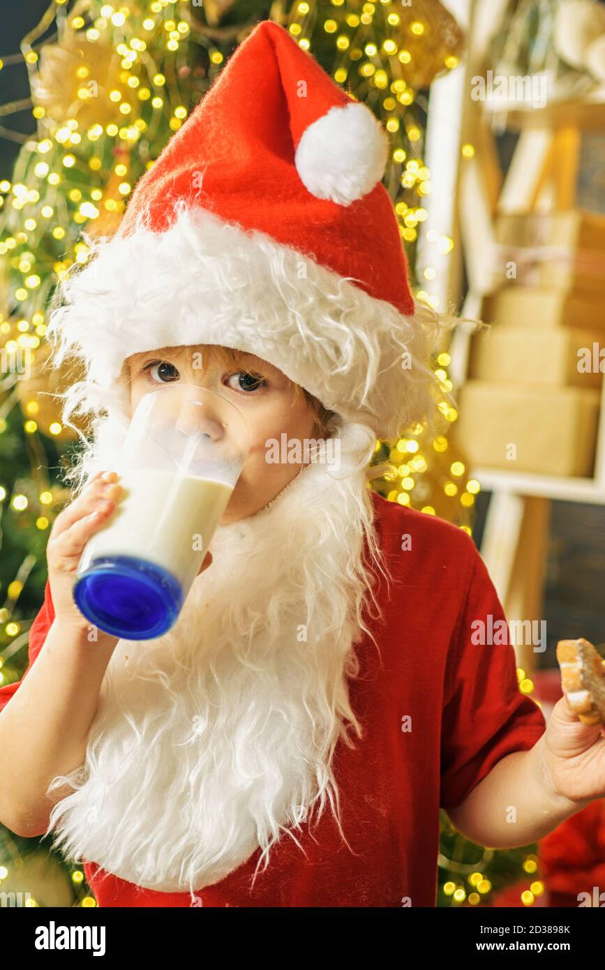Santa Claus eating cookies and drinking milk on Christmas Eve. Happy ...