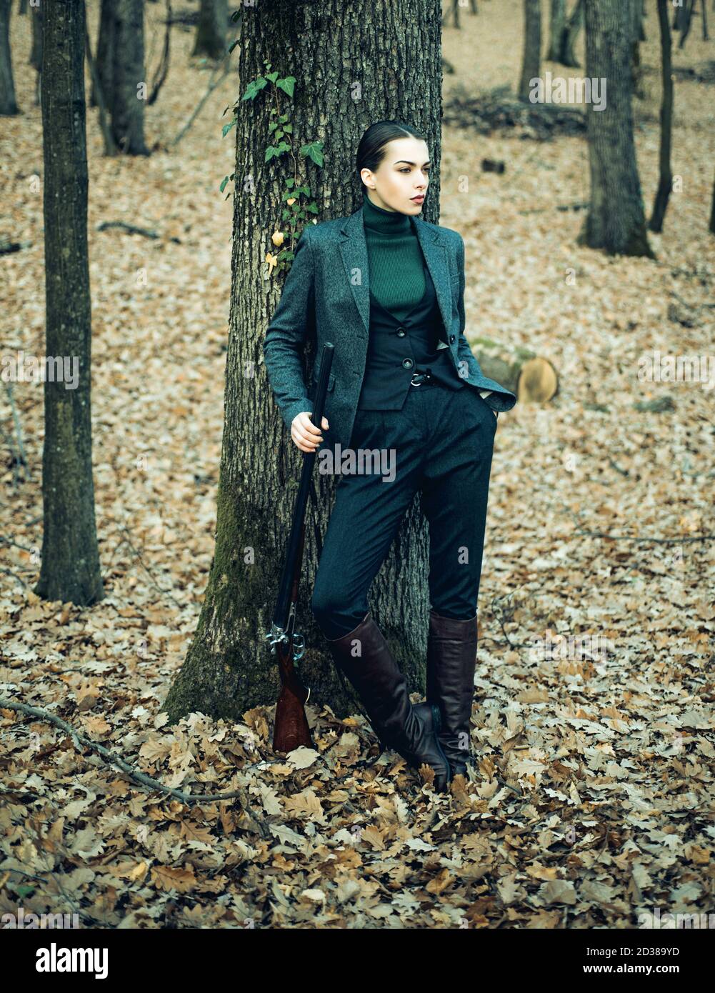 female hunter in forest. woman with weapon. Target shot. military ...