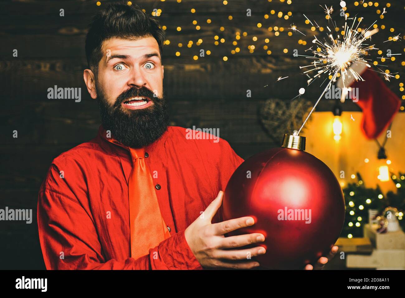 Christmas man in fashion red dress hold bomb. Christmas Celebration ...