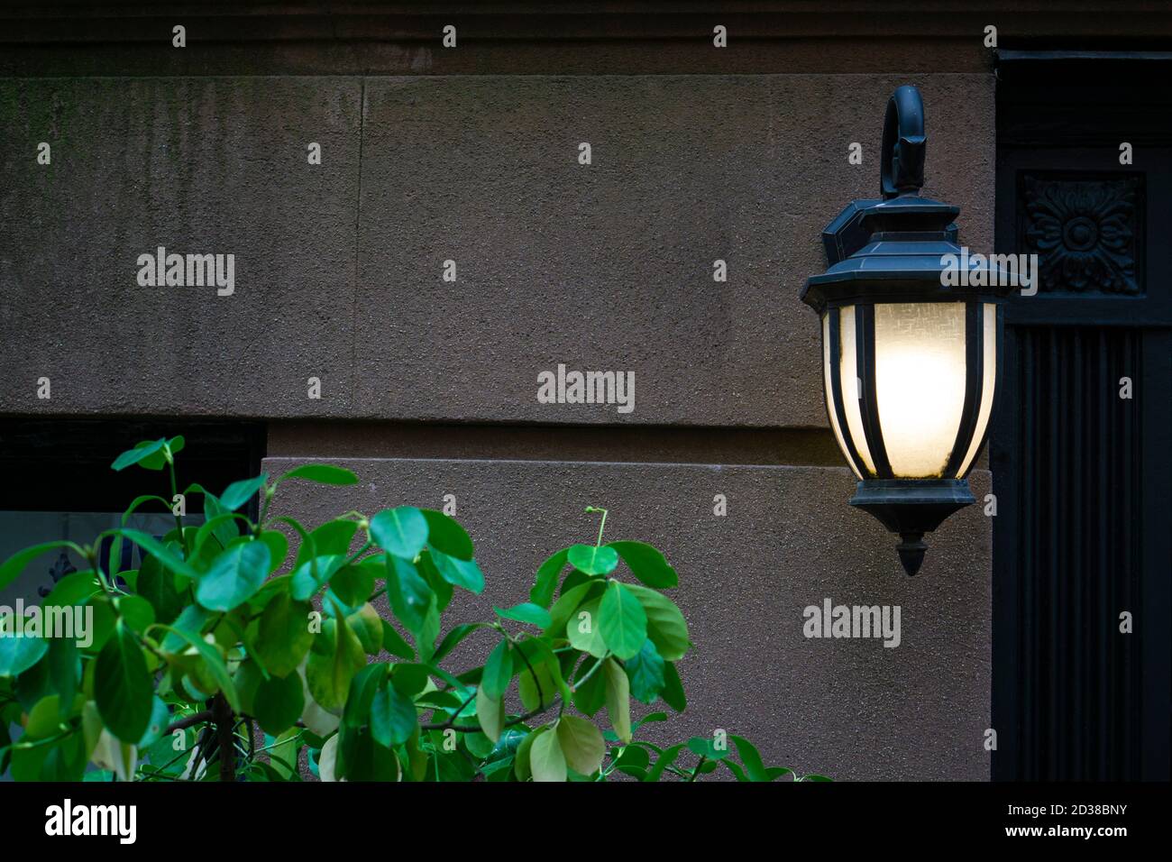 Close-up of old style street lamp in front of the building wall with ...