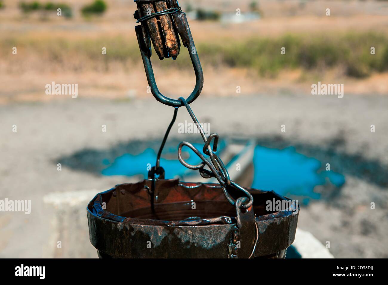 Rusty bucket of old water well Stock Photo - Alamy