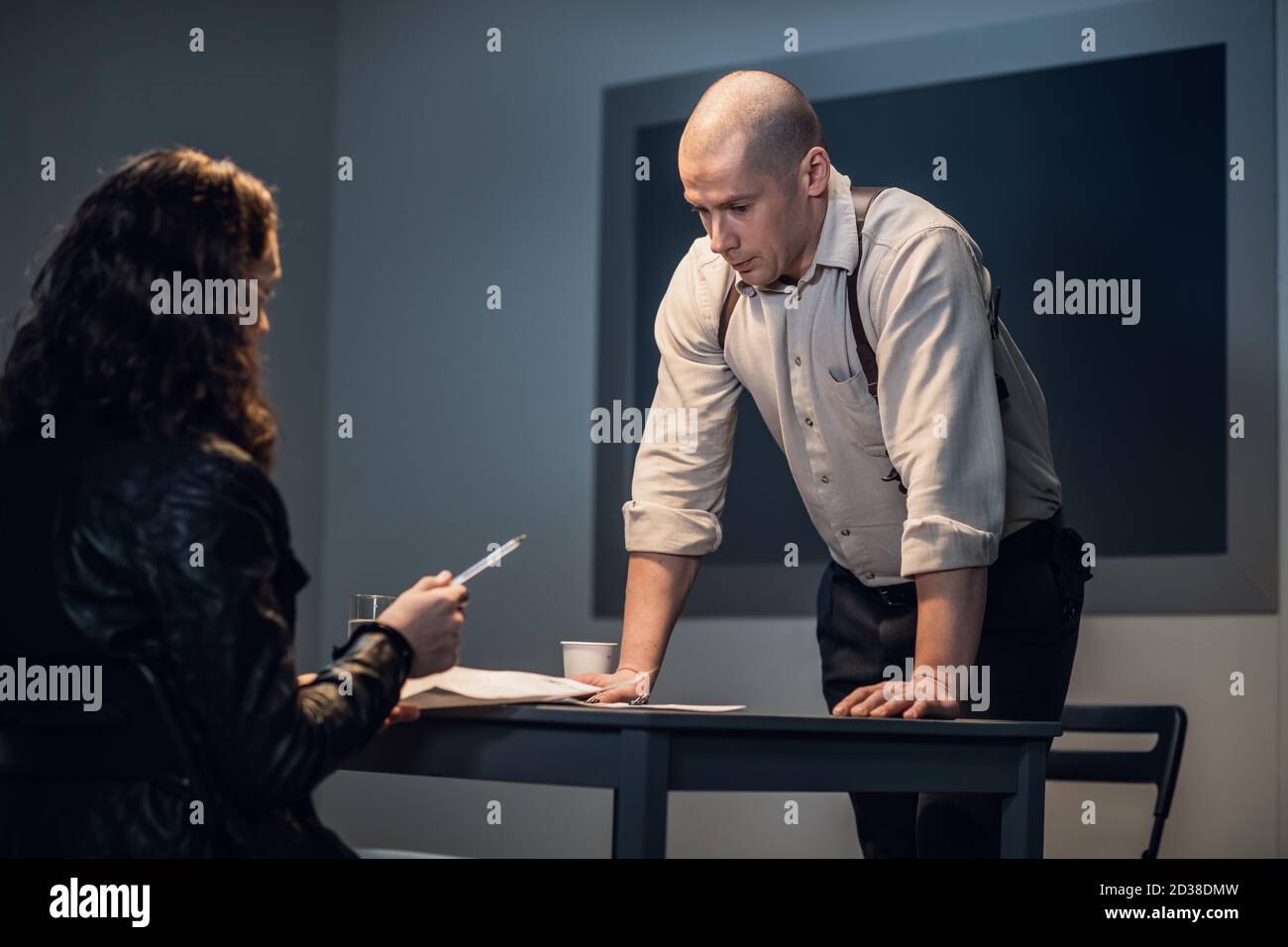 The detective introduces the suspect to the case materials, asks him to ...