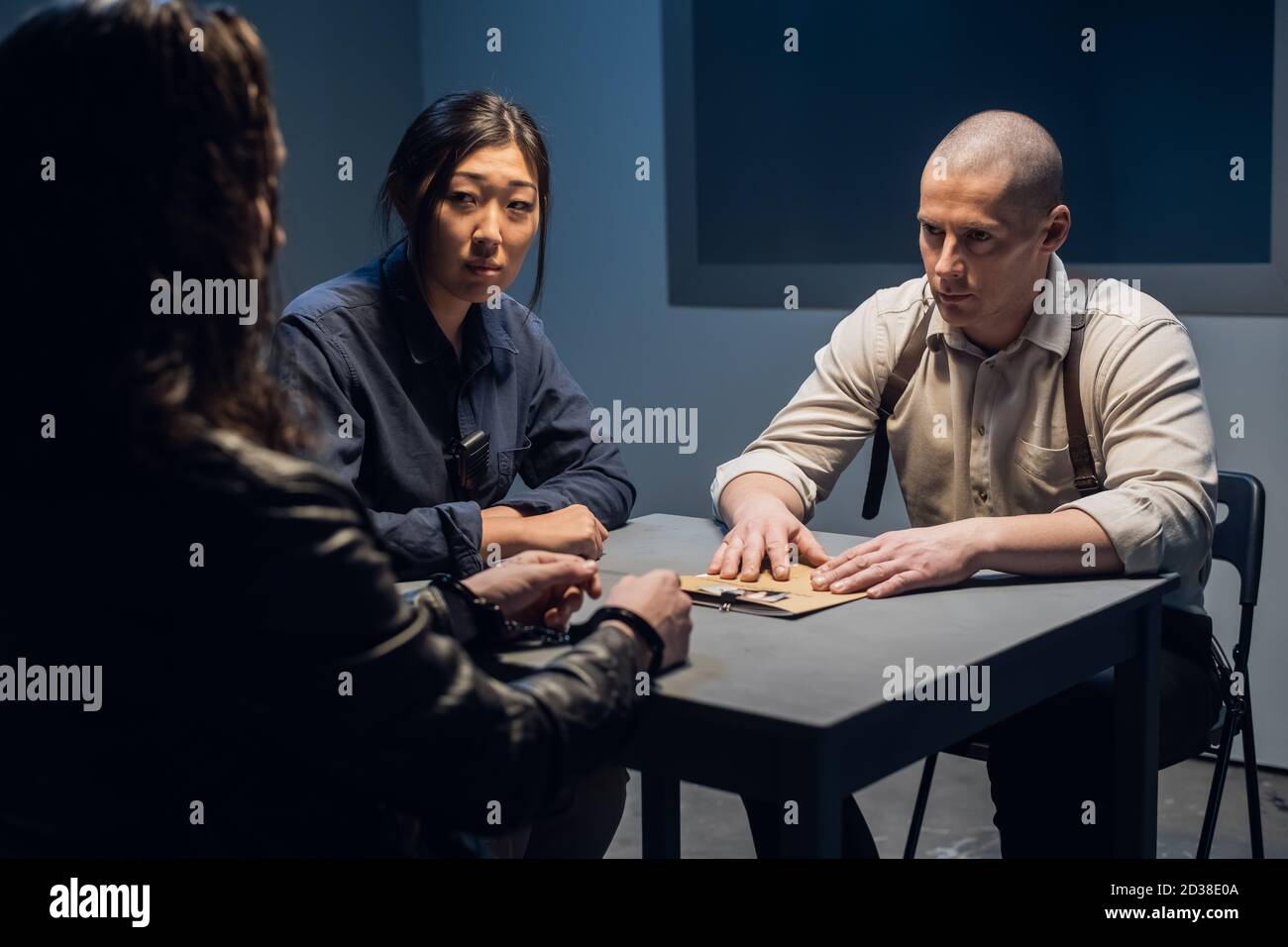 Two police officers a man and a woman are questioning the alleged ...