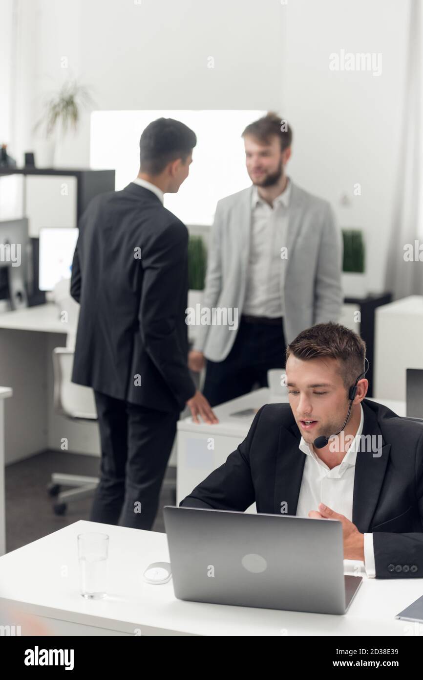 A call center employee sits at a Desk in the office of a large ...