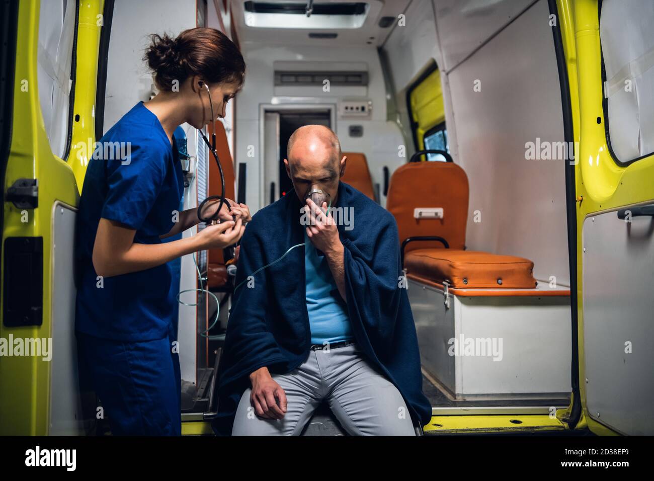 Female paramedic examining injured hi-res stock photography and images ...