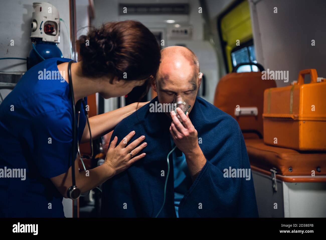 Medical worker providing psychological aid to a man rescued from the ...