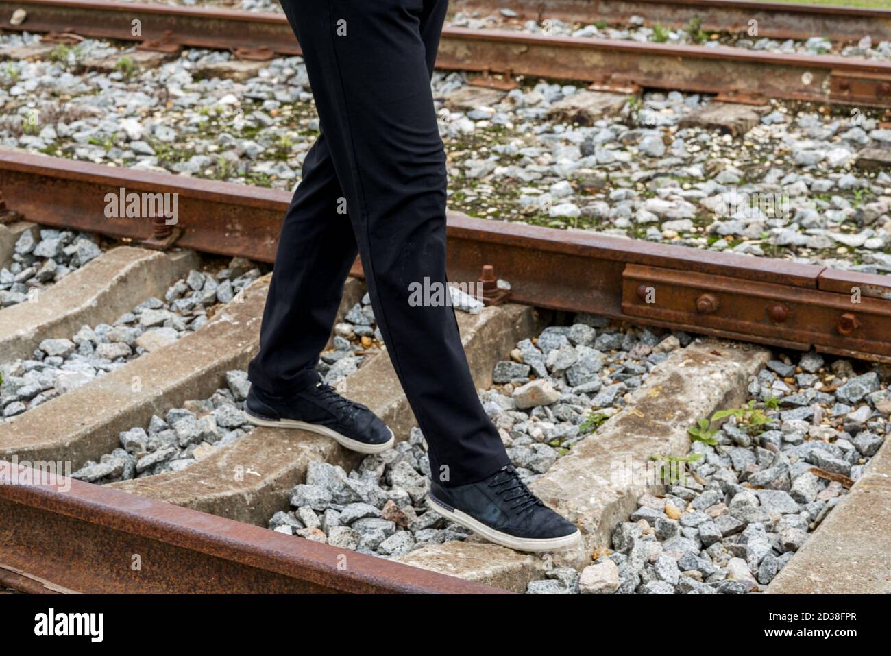 Walking alone on old railroad tracks Stock Photo - Alamy